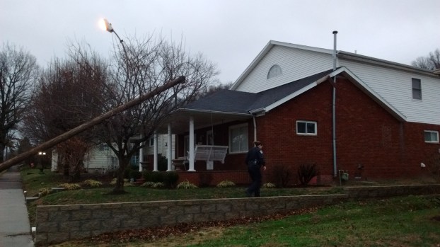 Fallen light post misses house, drops line over cars | The Tribune