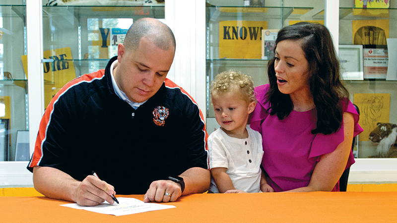 Signing the dotted line: McKnight signs on as teacher at IES | The Tribune